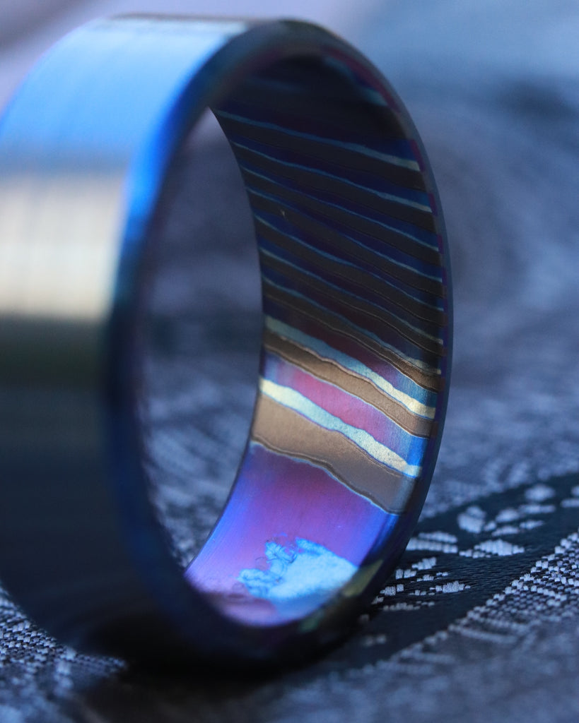 Matching set of two Black & blue titanium ZrTi band black titanium ...